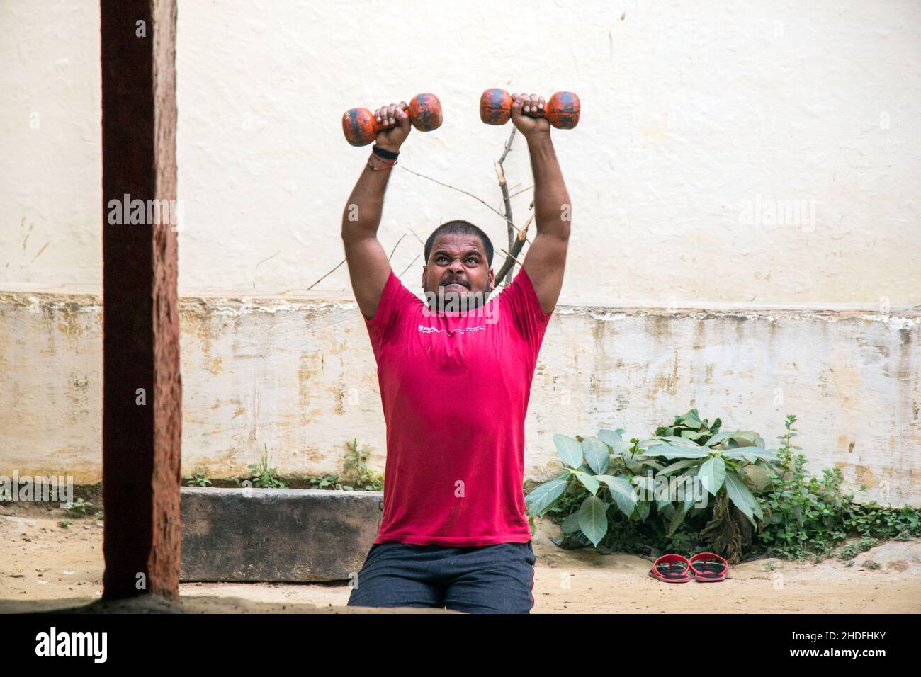Unidentified Indian wrestlers do exercise by lifting their traditional ...