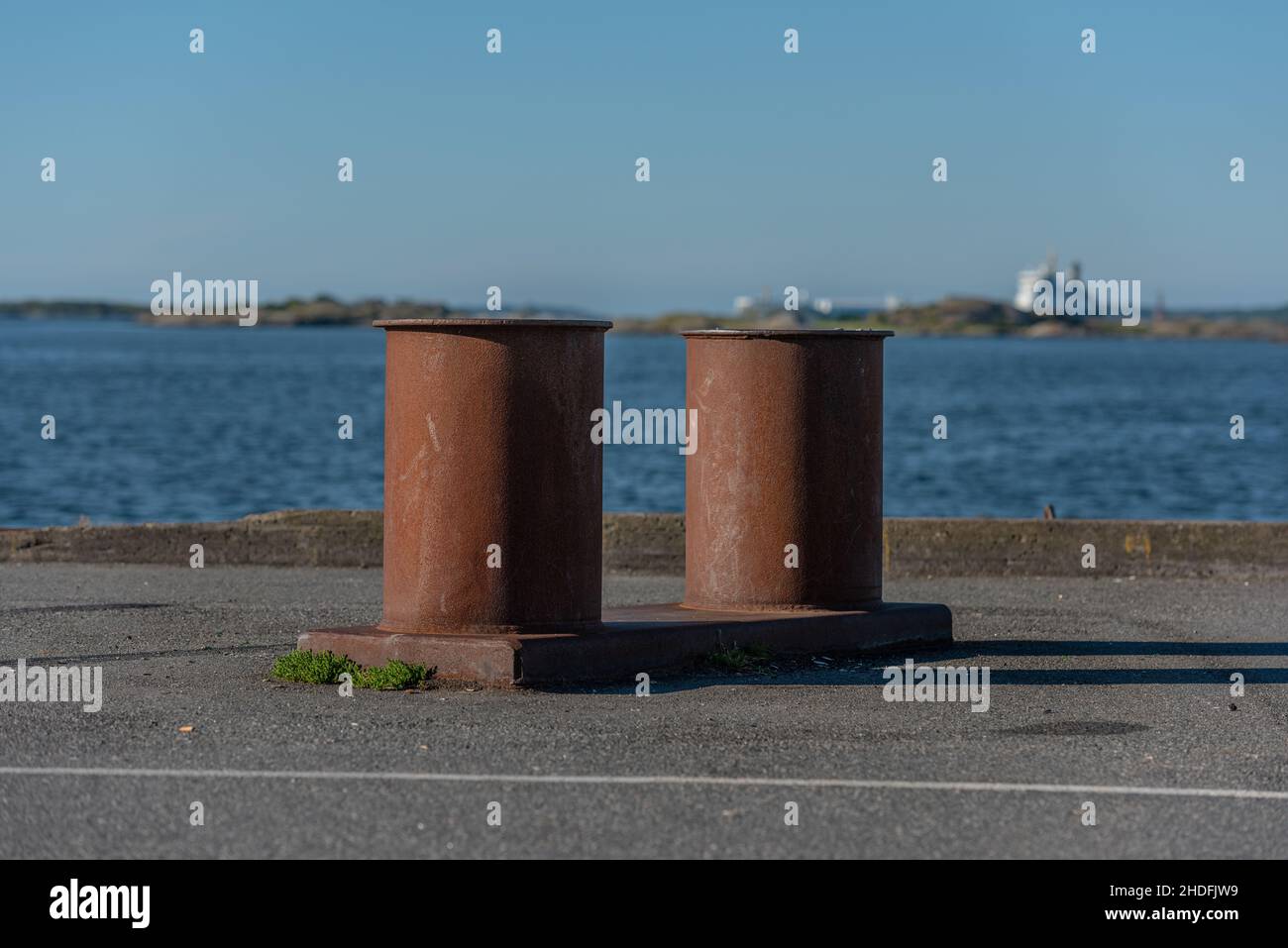 Large rusty iron bollards at a dock Stock Photo - Alamy