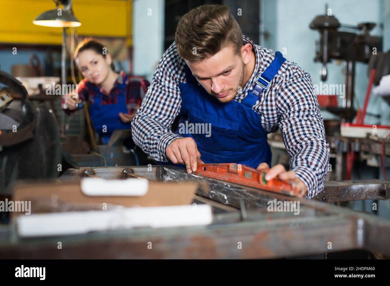 master working with level Stock Photo - Alamy