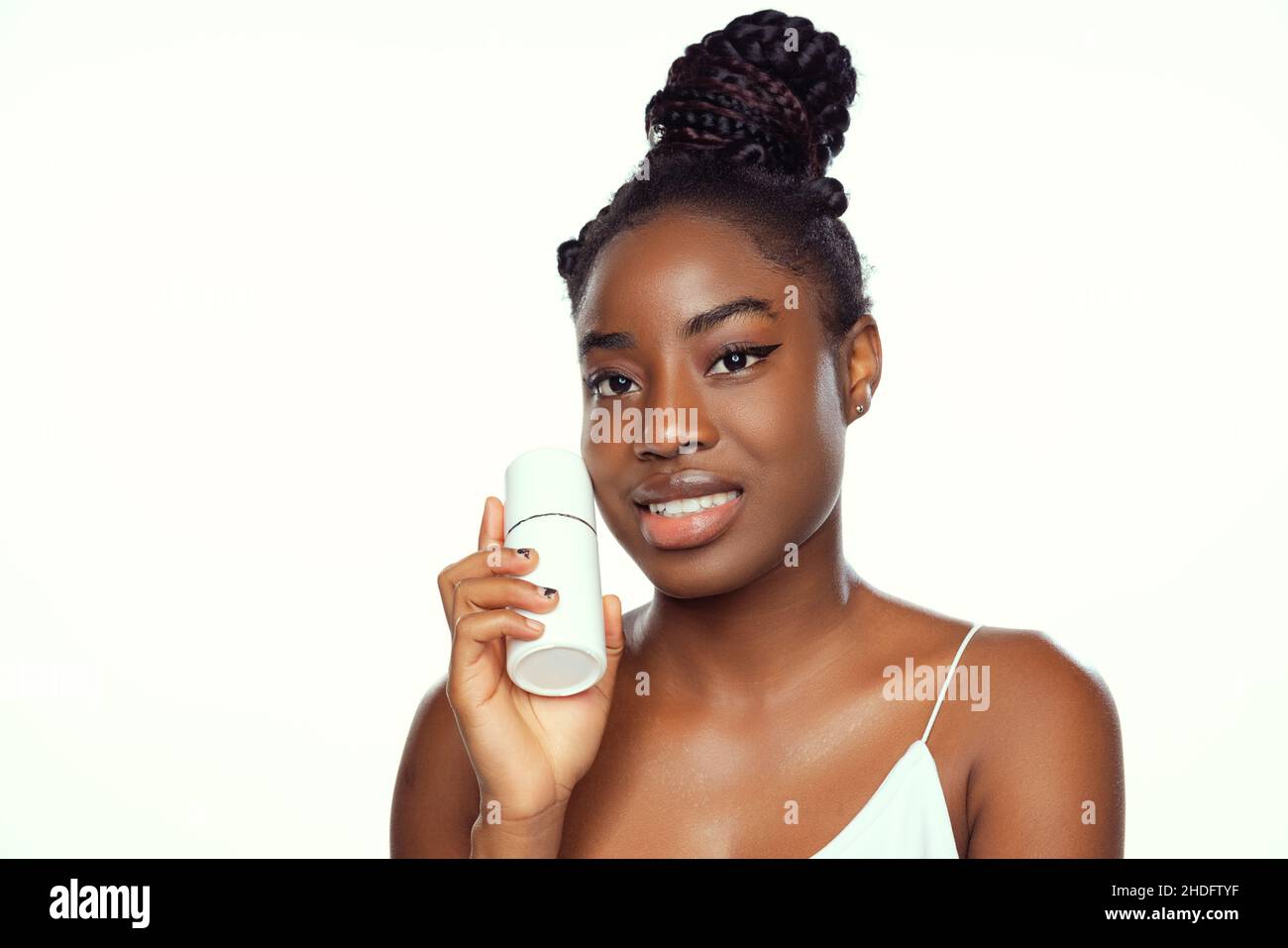 Portrait of young female fashion model using cosmetic product isolated ...