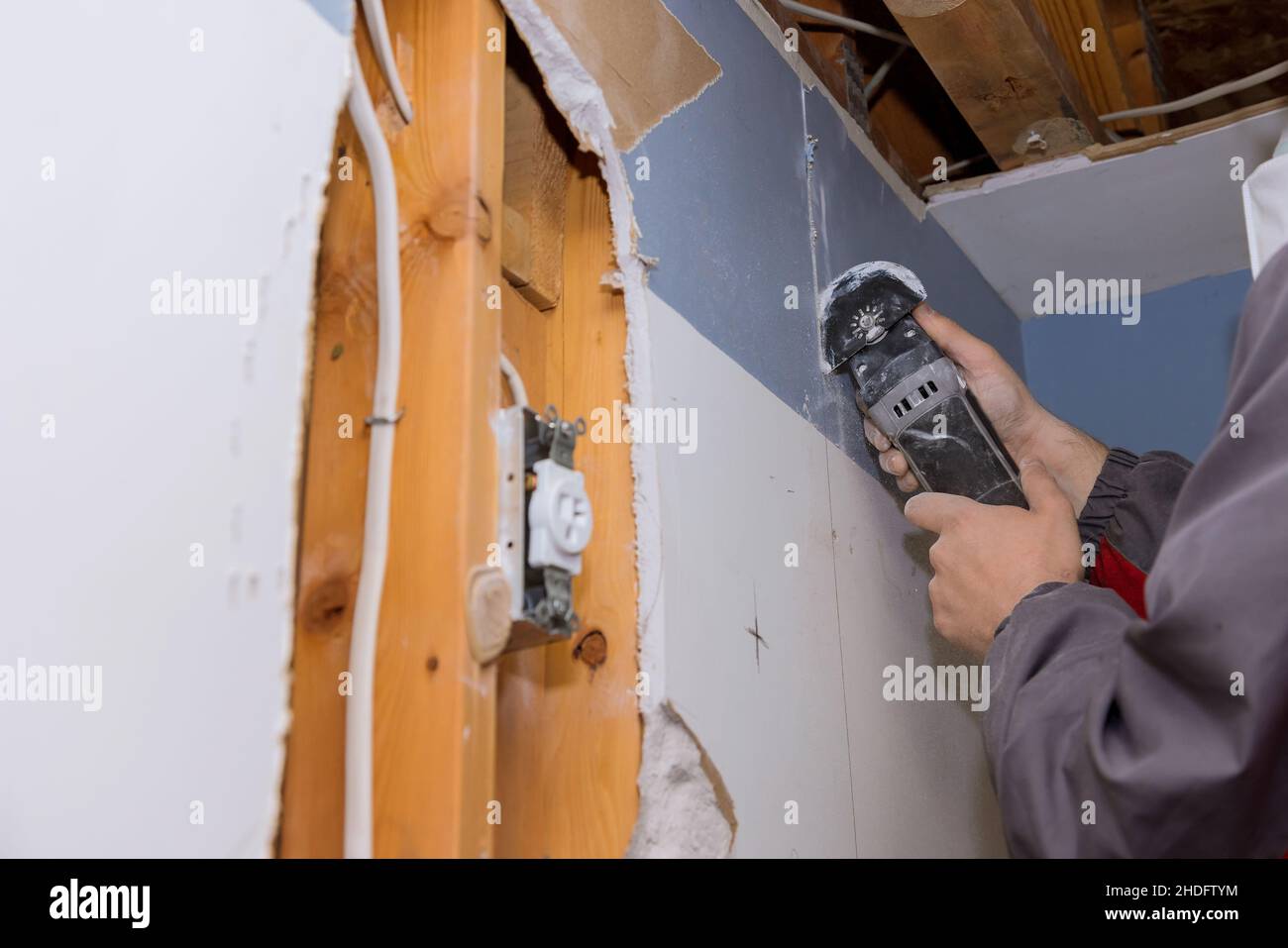 Maintenance repair works of replacement damaged drywall on worker ...