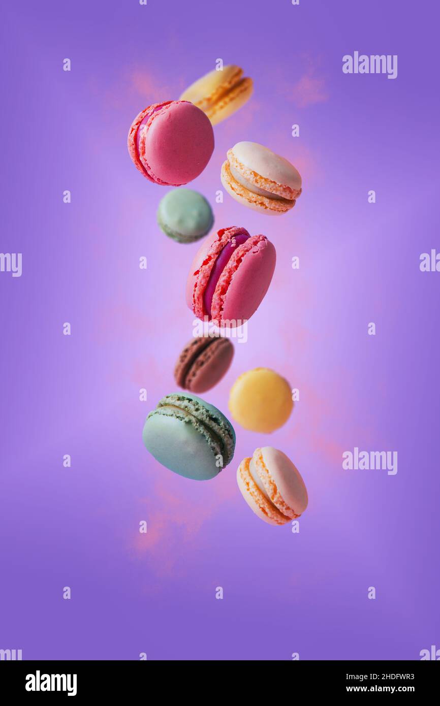 Floating macarons dessert on pastel tones background. Copy space Stock ...