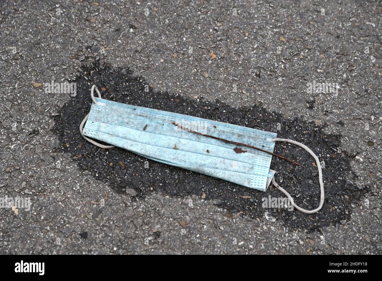 Used protective mask thrown on the ground. Protective mask on the ...