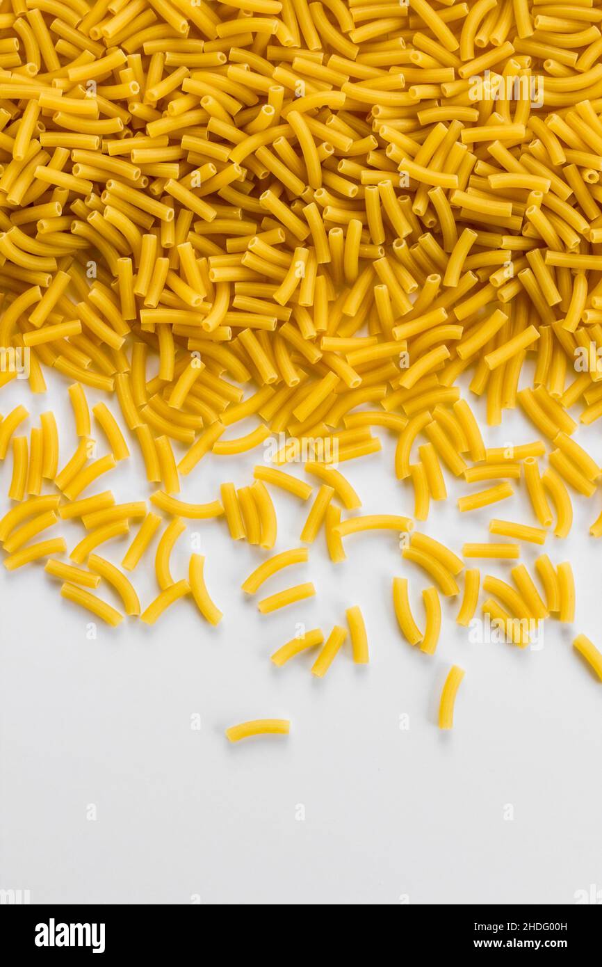 Uncooked,short cut pasta on white background with copy space Stock ...