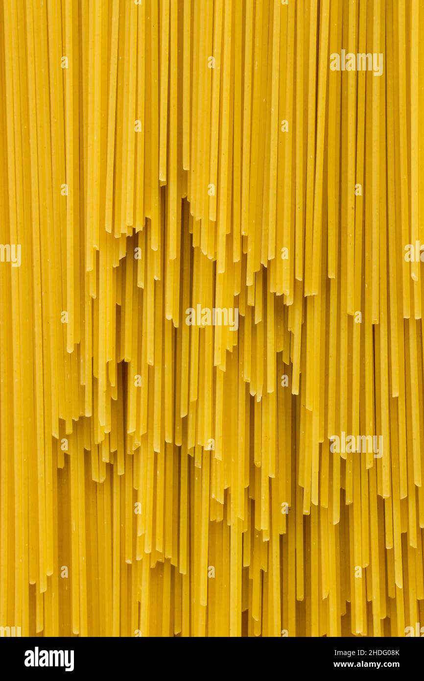 Uncooked,dry traditional spaghetti,pasta sticks background,vertical ...