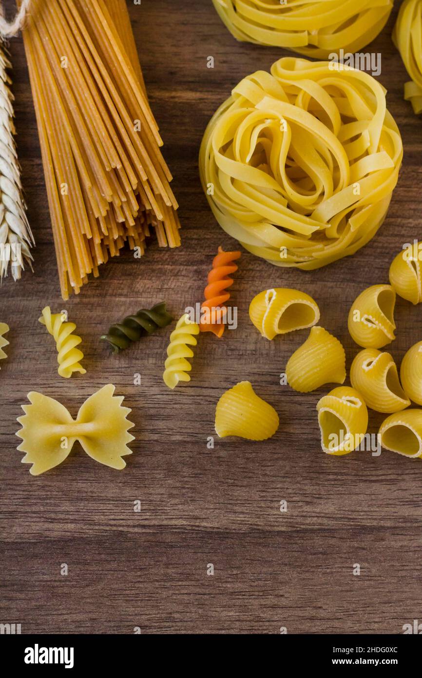 Various of uncooked pasta or macaroni on wooden table with copy space ...