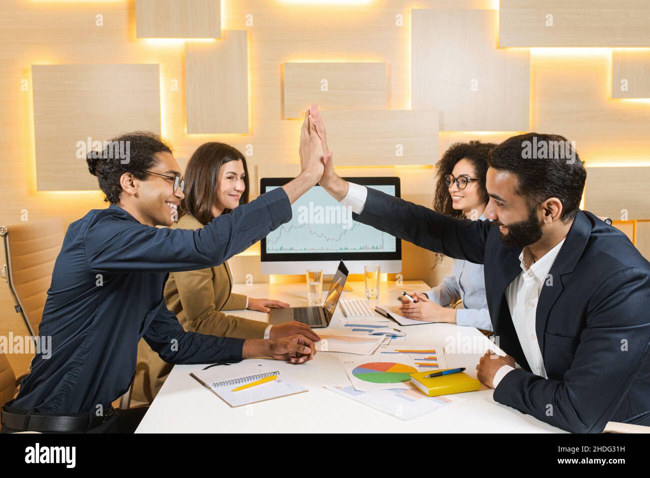 Full length side view outgoing businessmen giving high five while ...