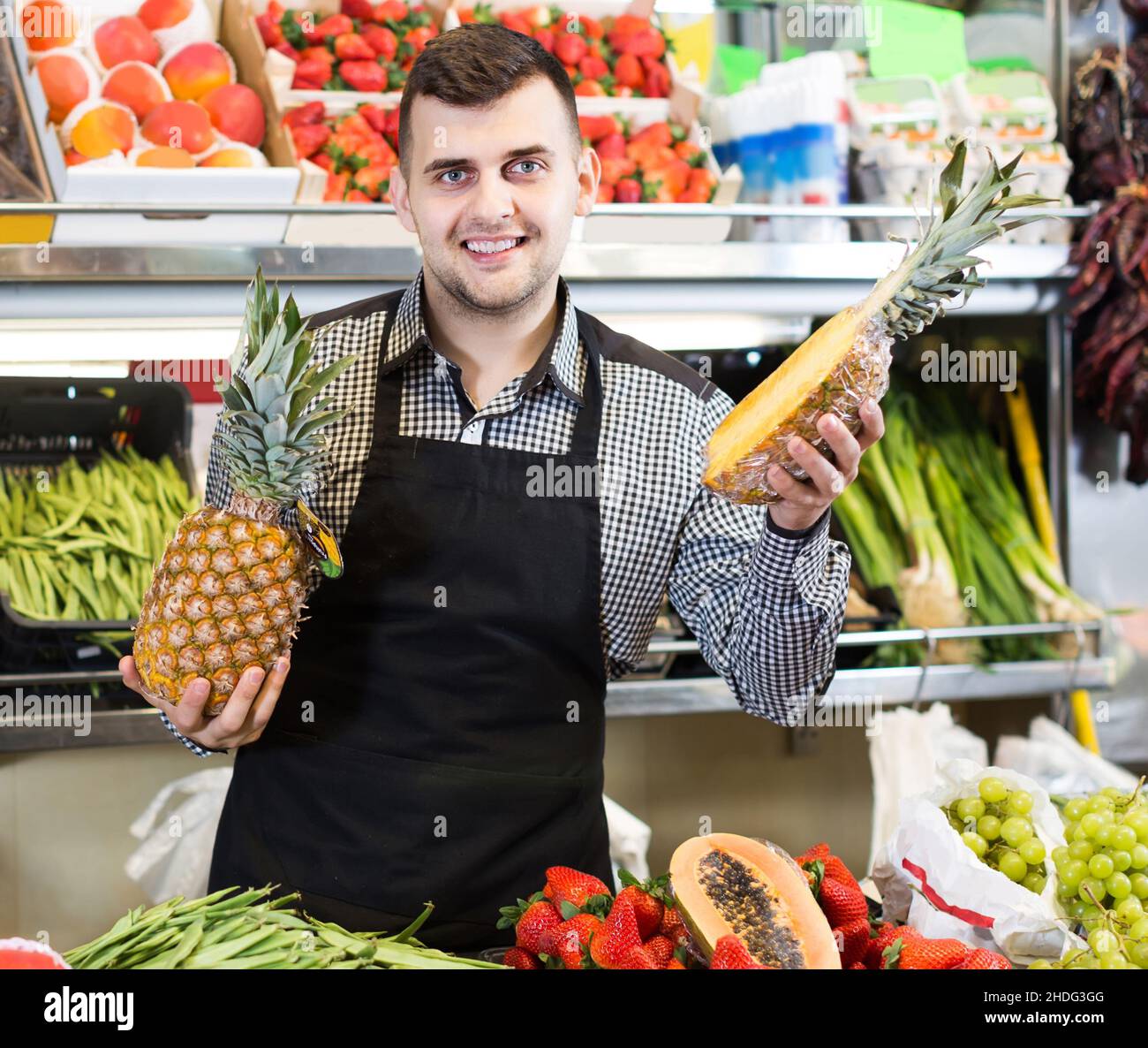 shopping assistant demonstrating assortment of grocery shop Stock Photo ...
