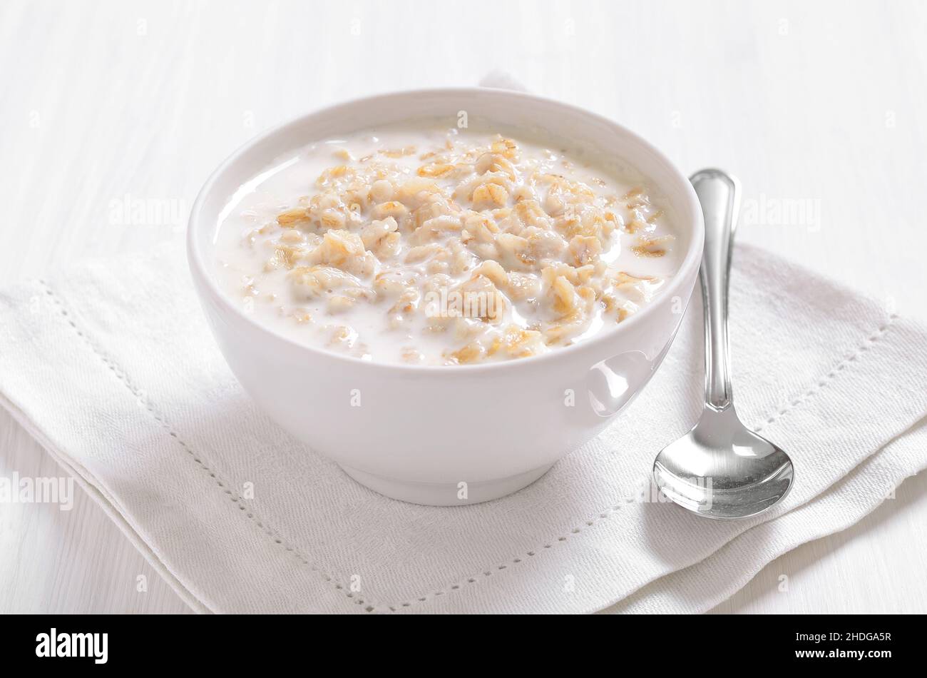 Oatmeal porridge in white bowl, close up view Stock Photo - Alamy