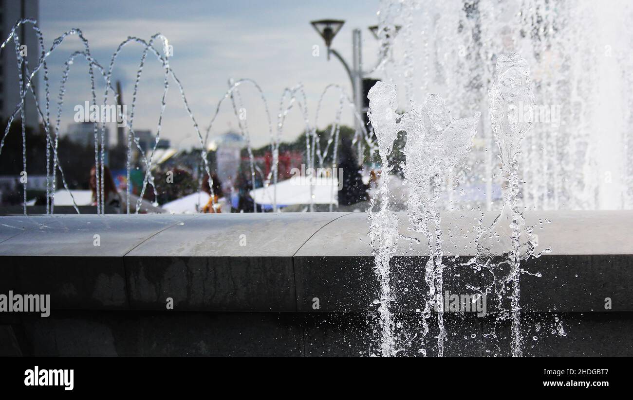 Low fountains splashing from the floor in the city park Stock Photo - Alamy