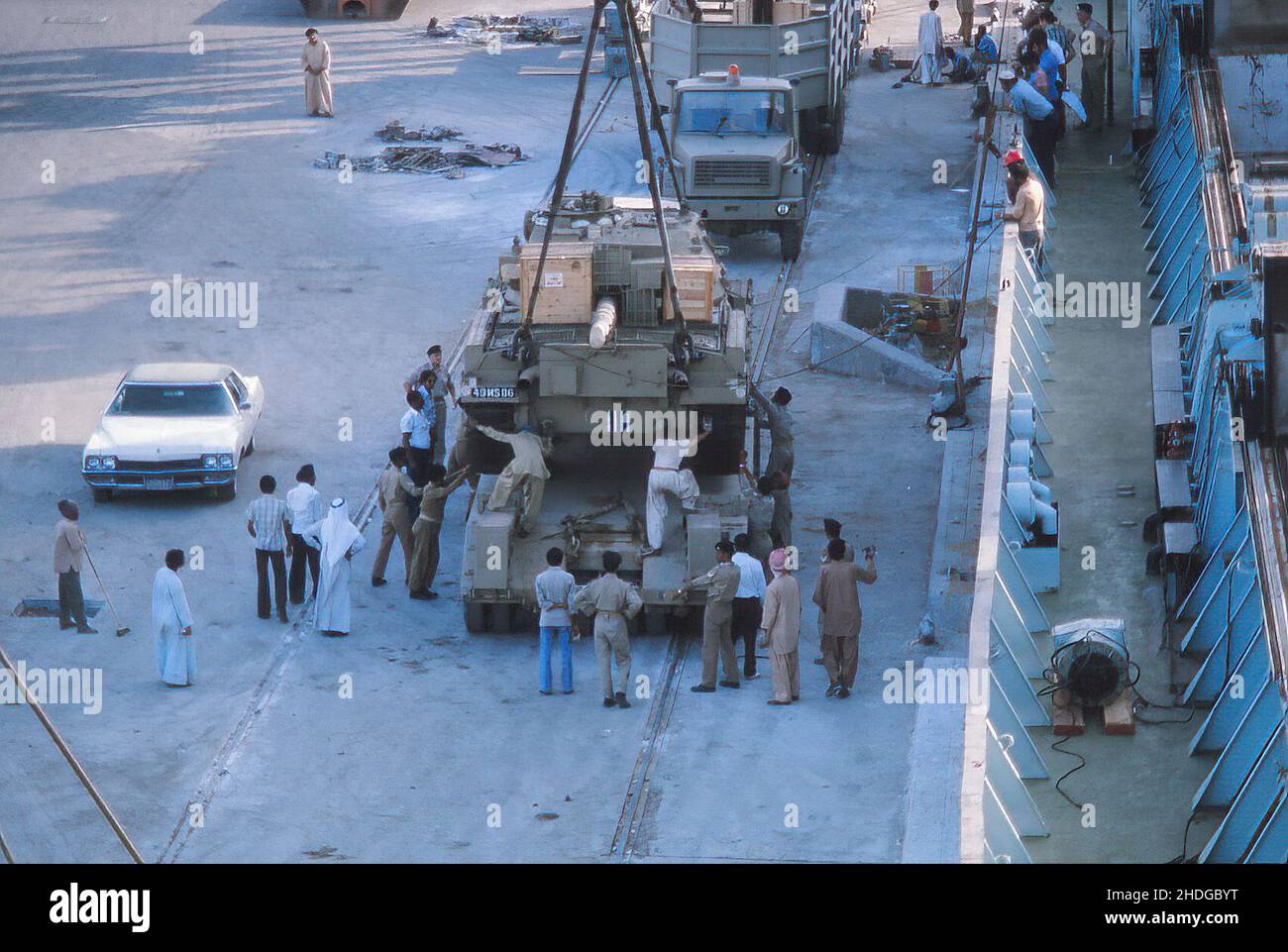 A suspended Chieftain Tank being guided onto a tank transporter on the ...