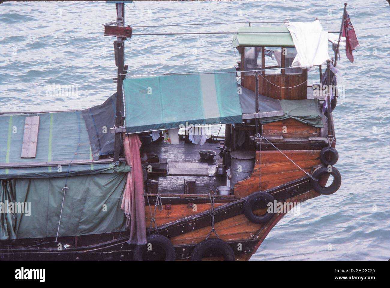 The stern of a Hong Kongese or Chinese barge flying the red ensign ...