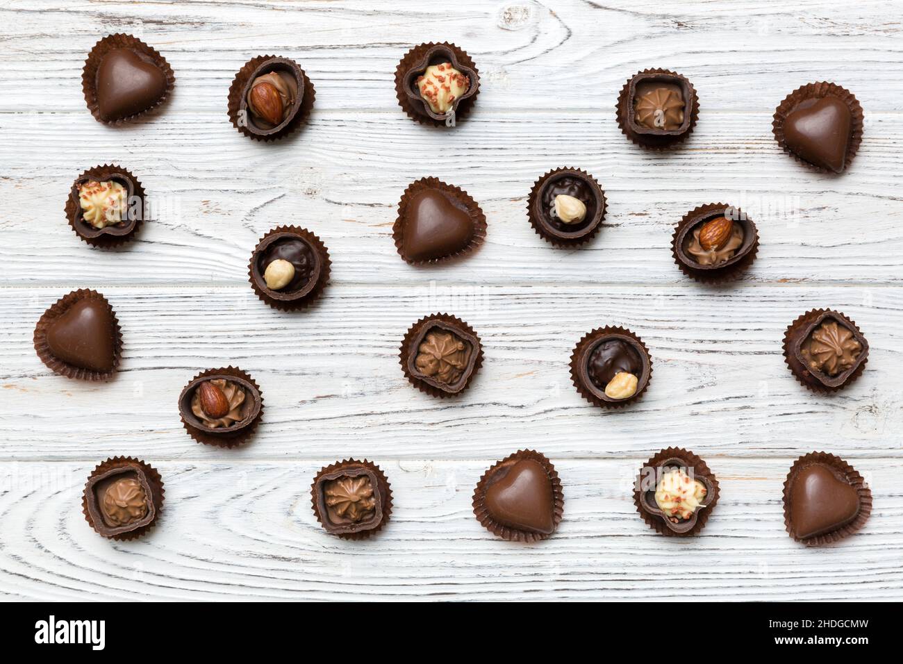 Different kinds of chocolates on colored table close-up. Top View and ...