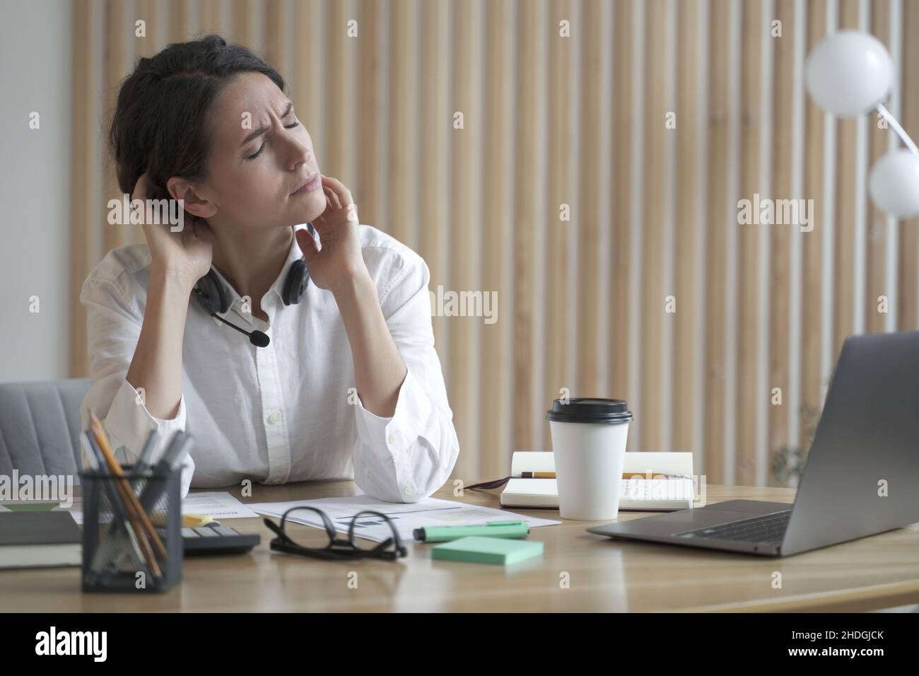 Overworking remote call center operator lady suffers from fatigue and ...