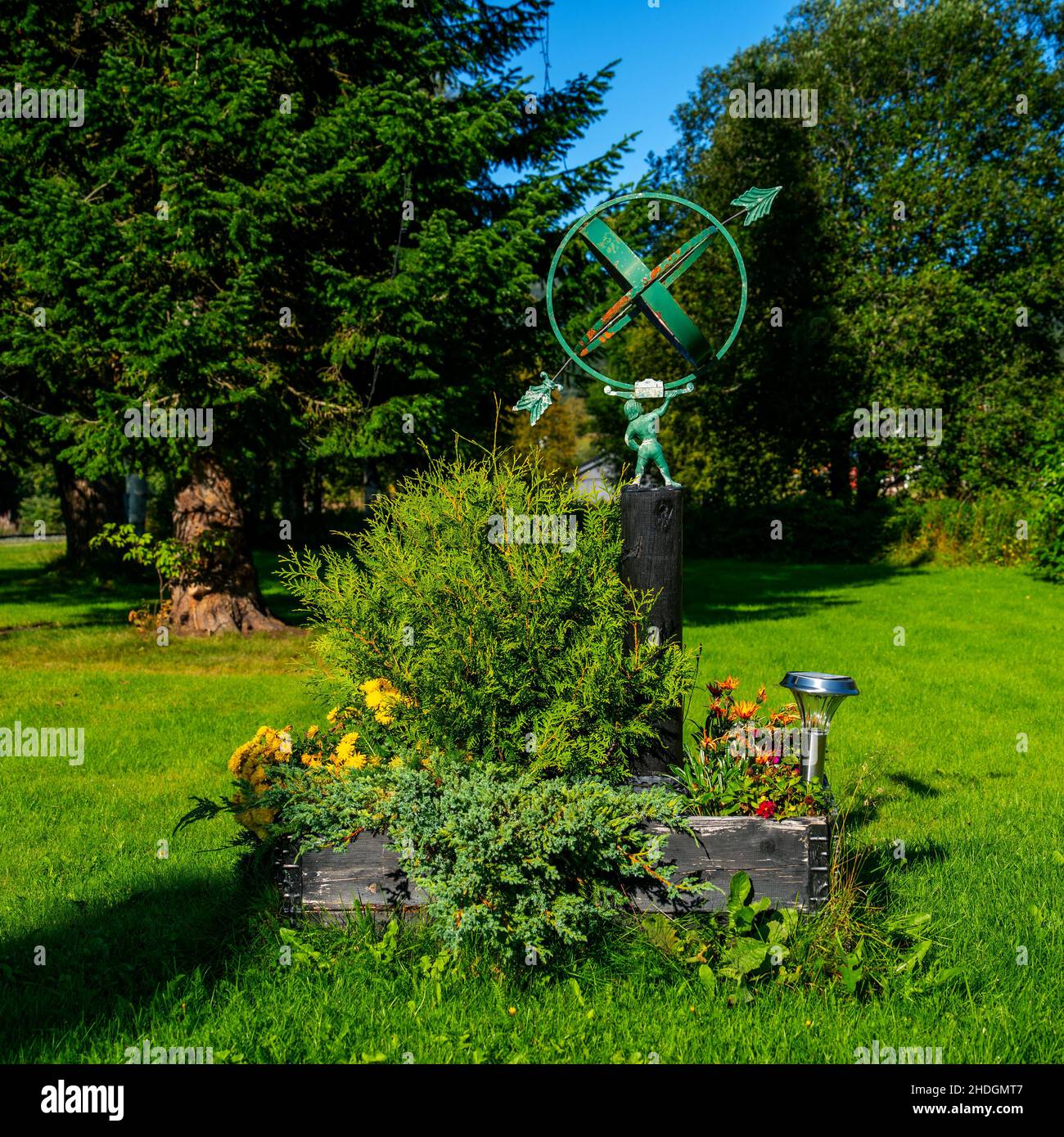 Flower bed with sundial in a garden Stock Photo - Alamy
