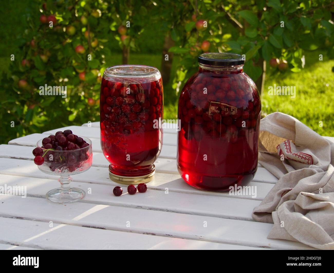 cherry compote drink on garden background Stock Photo - Alamy