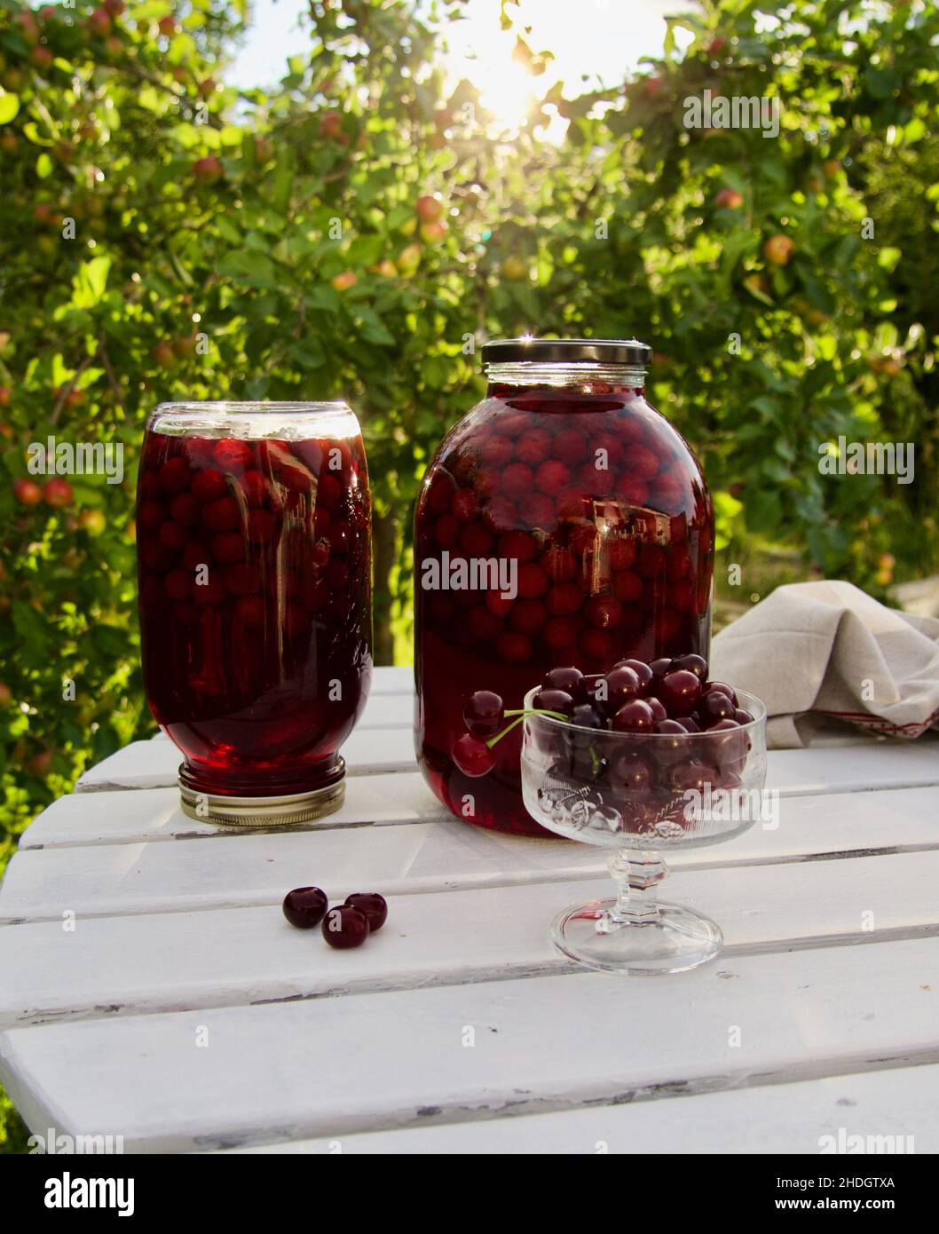 cherry compote drink on garden background Stock Photo - Alamy