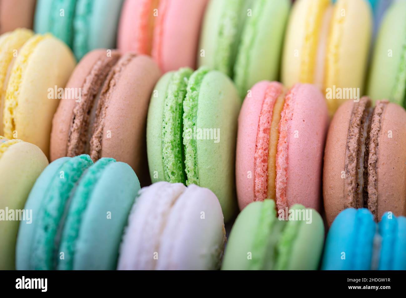 Background of colored sweet macaroons with bokeh Stock Photo - Alamy