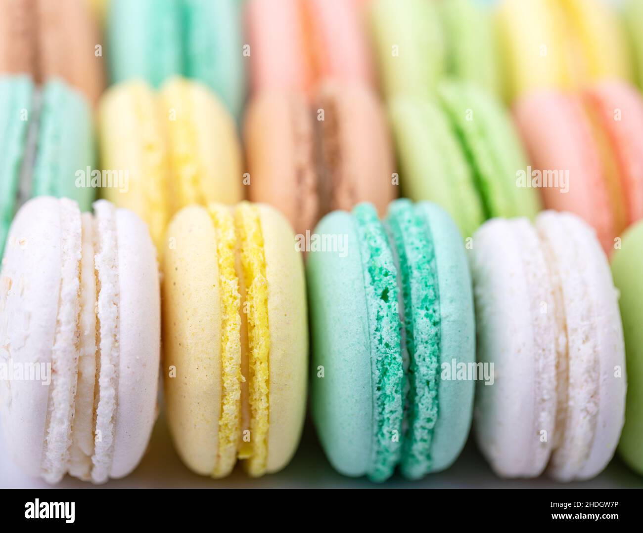 Background of colored sweet macaroons with bokeh Stock Photo - Alamy