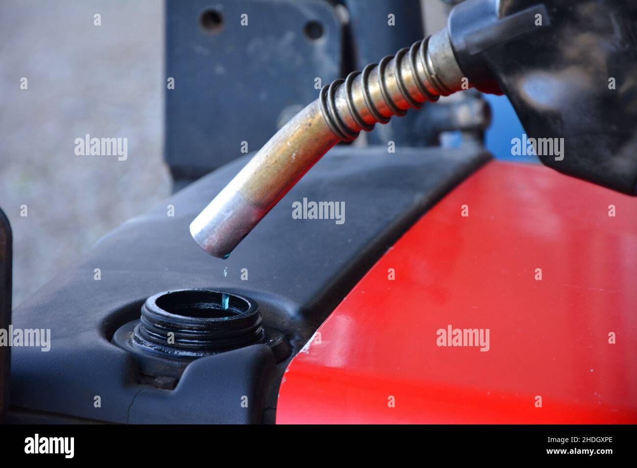 Refueling a tractor with diesel from the nozzle Stock Photo - Alamy