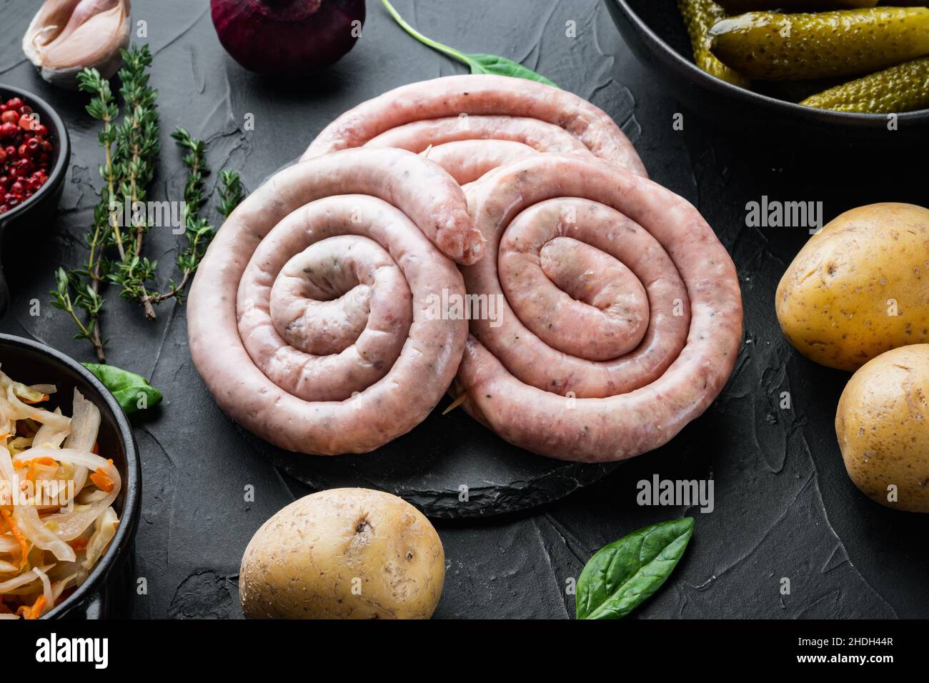 Raw snail sausage in traditional spiral set, on black background Stock ...
