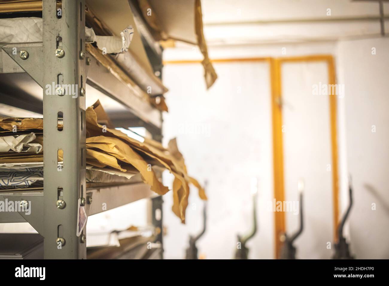 Printing house warehouse and metal shelf with paper. Working process ...