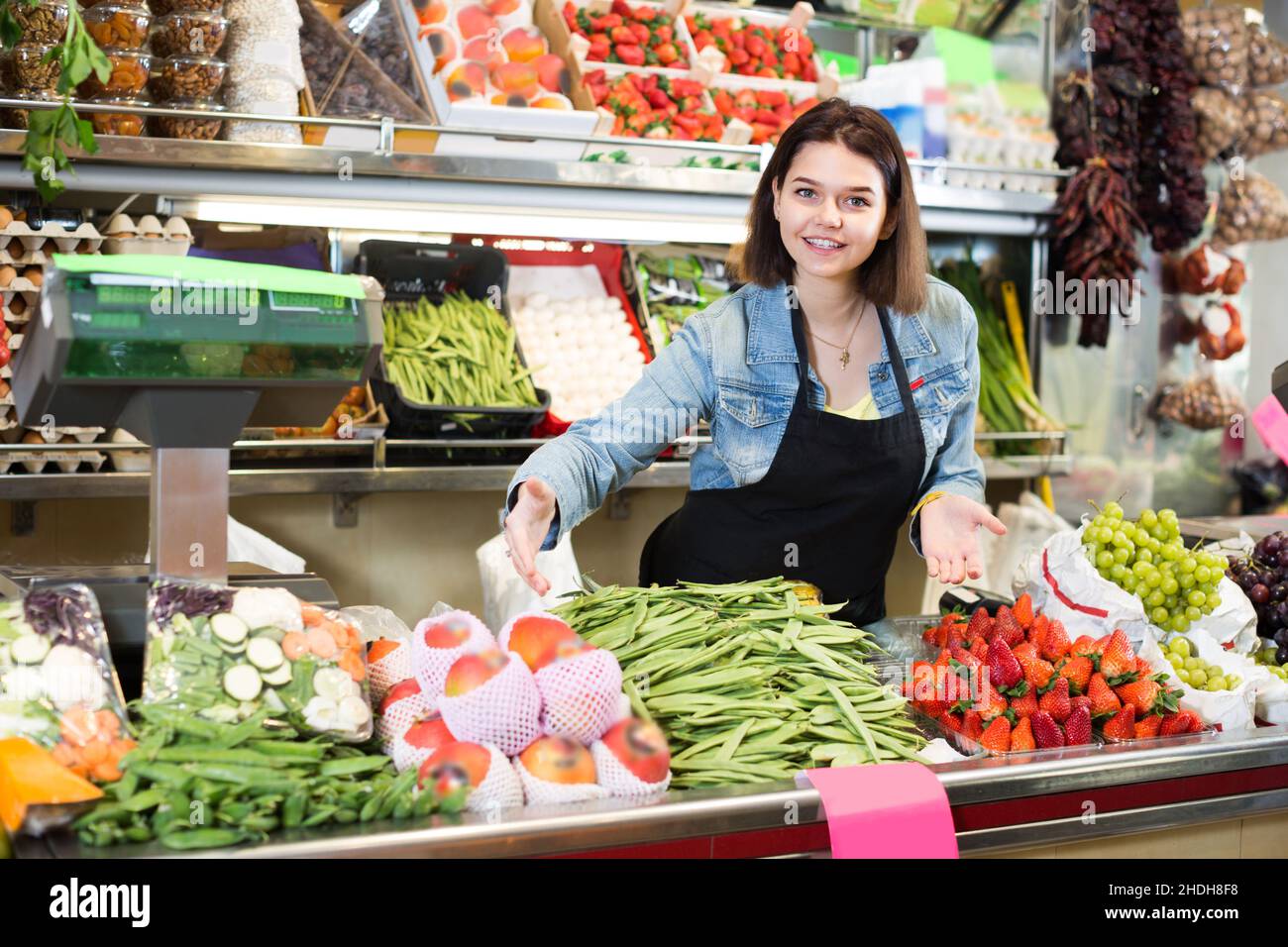 Female shop assistant is showing assortment Stock Photo - Alamy