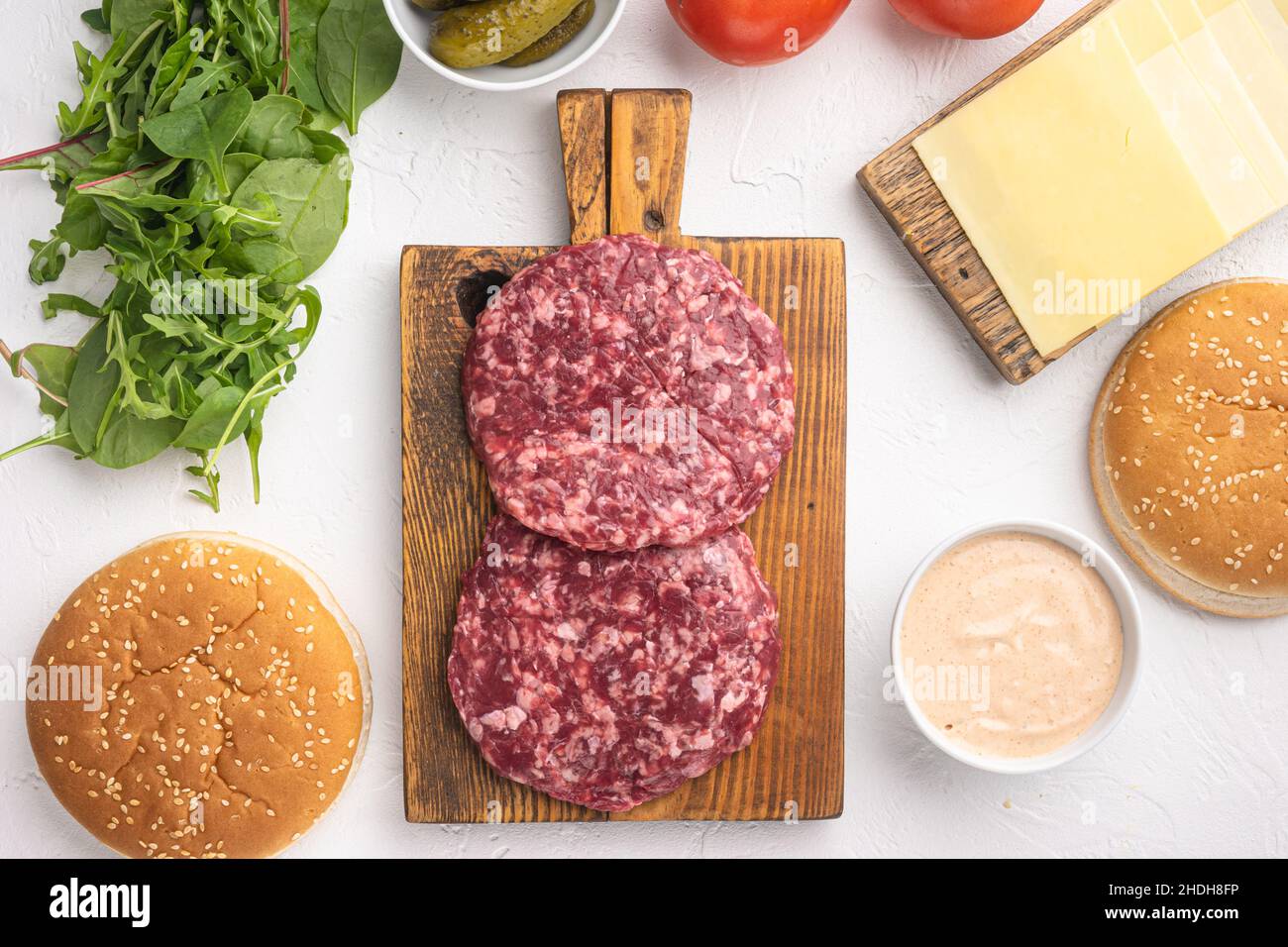 Raw Ground beef meat Burger steak cutlets with ingredients and buns set ...