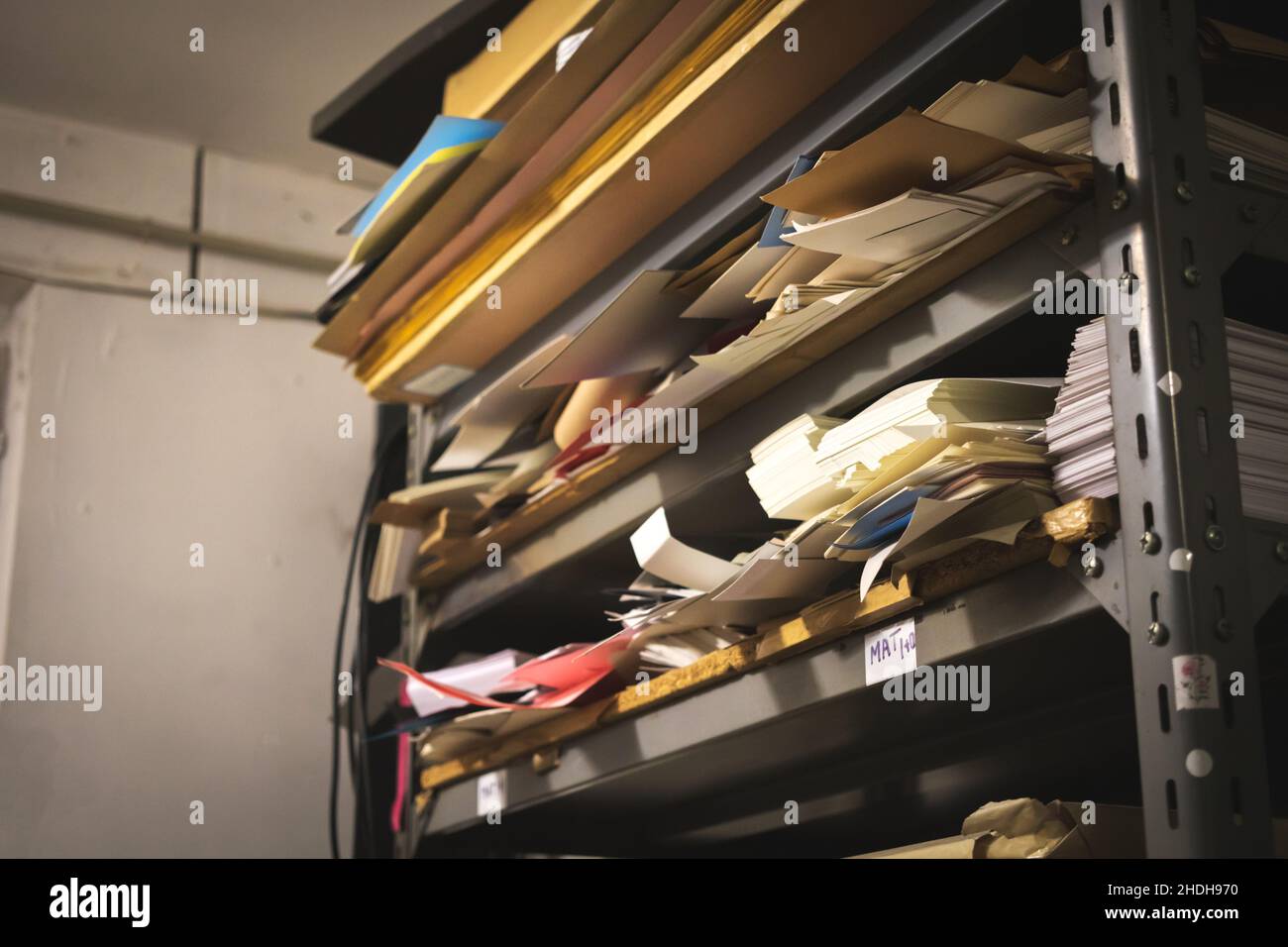 Printing house warehouse and metal shelf with different type of paper ...