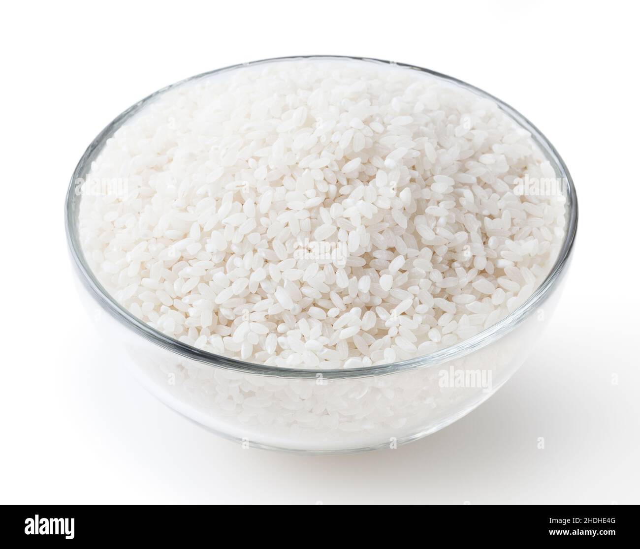 Uncooked round rice in glass bowl isolated on white background with ...