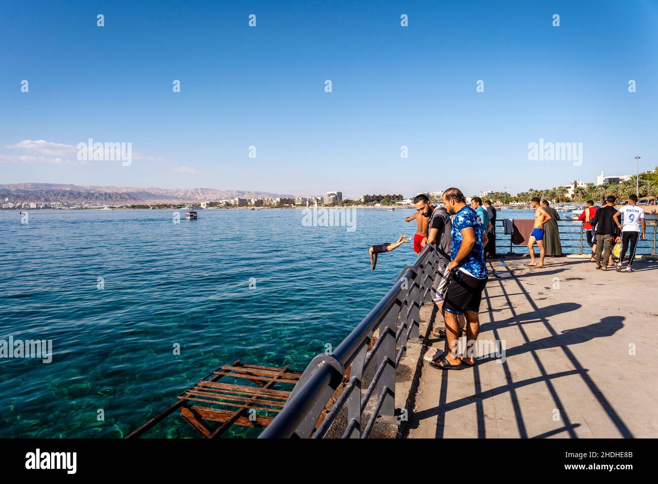 Young People Diving Off A Platform On The Public Beach In Aqaba, Aqaba ...