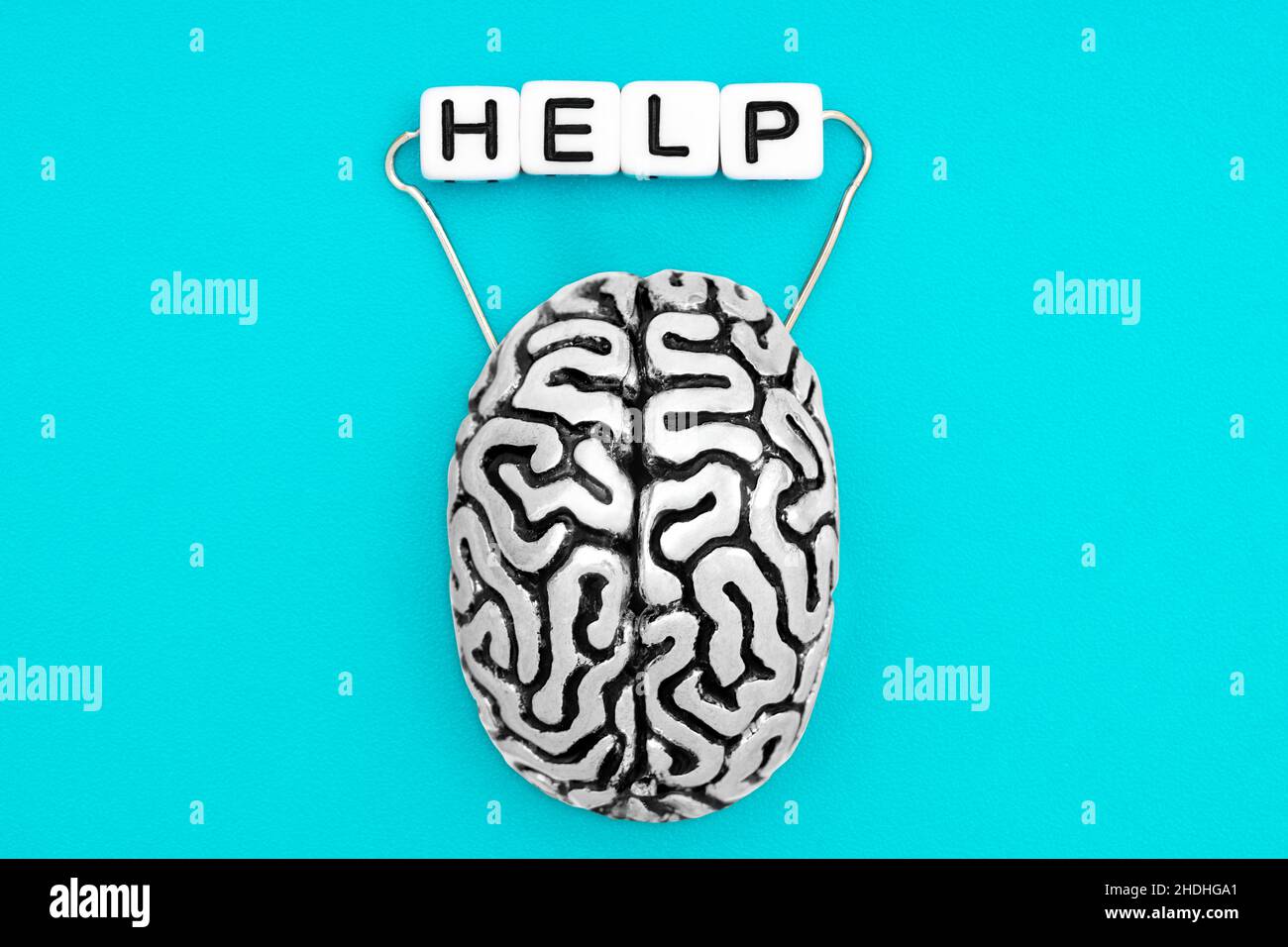 Anatomical copy of a human brain holding a help sign. Asking for help ...