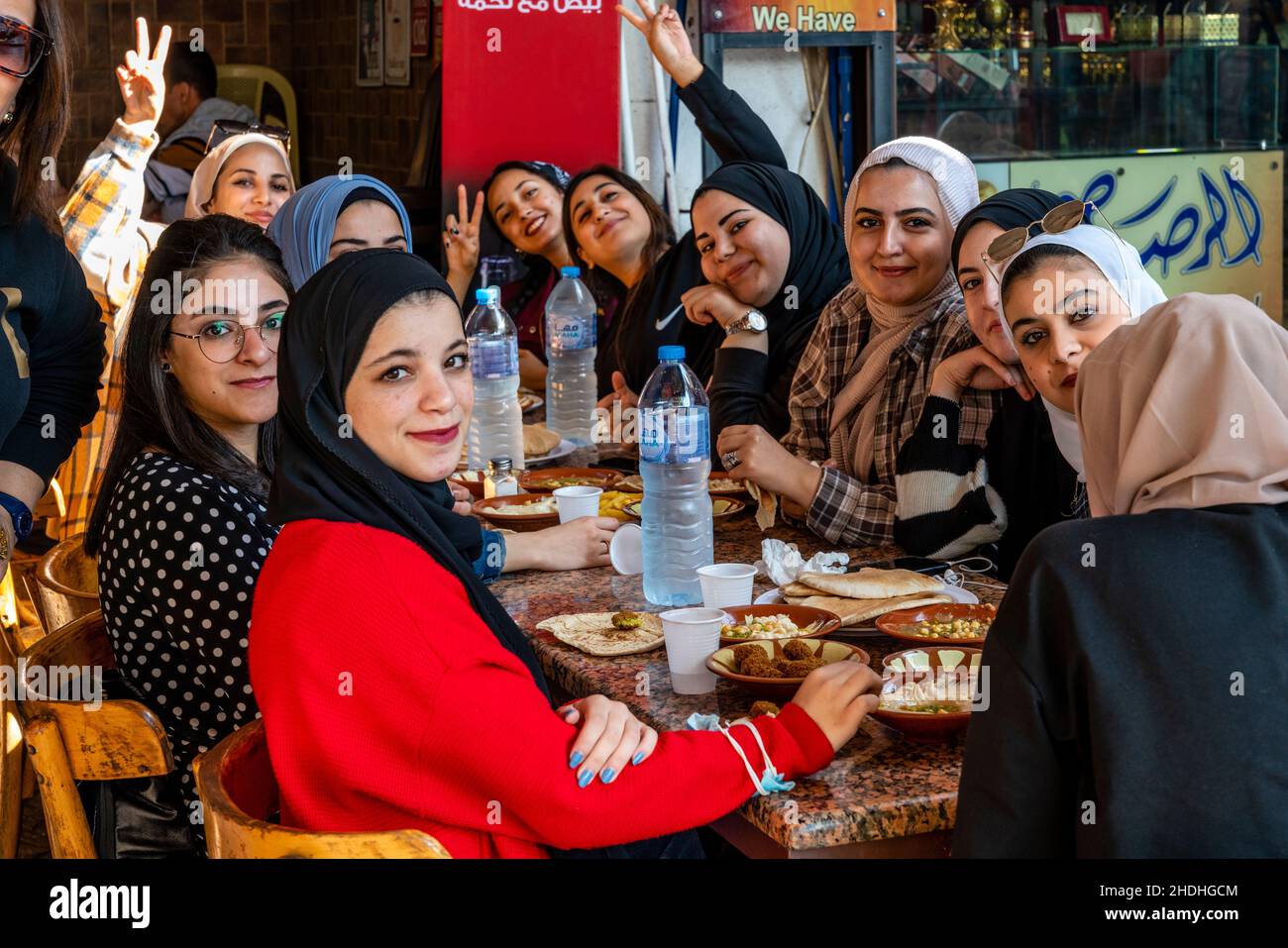 A Group Of Young Jordanian Women Enjoy Breakfast Outside A Cafe In ...