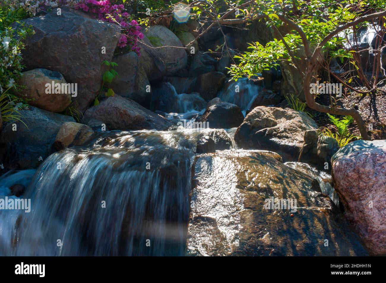 Beautiful small waterfall in a japanese style garden Stock Photo - Alamy