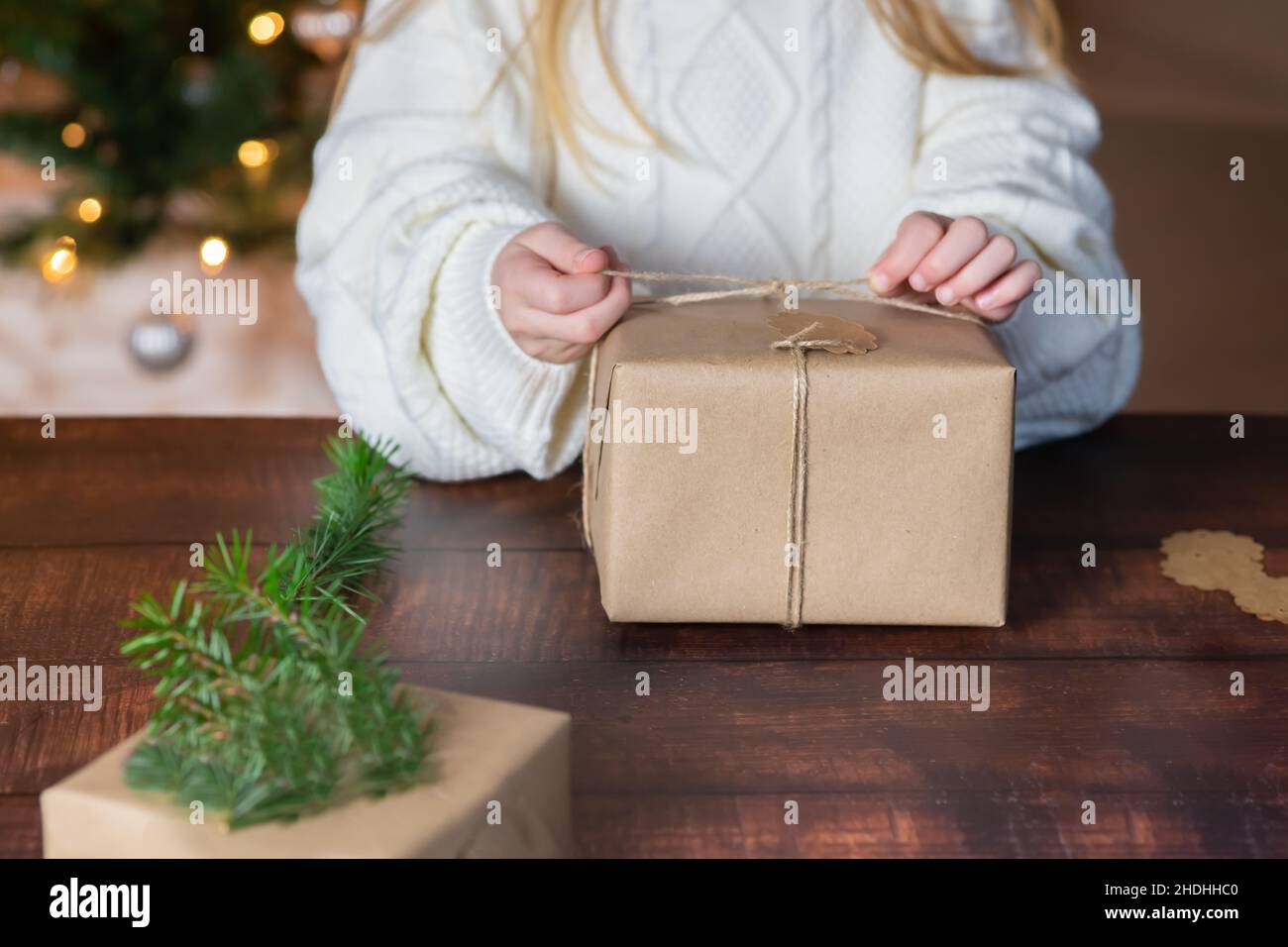 Girl's hands decorating Christmas and New Year gifts during holidays in ...