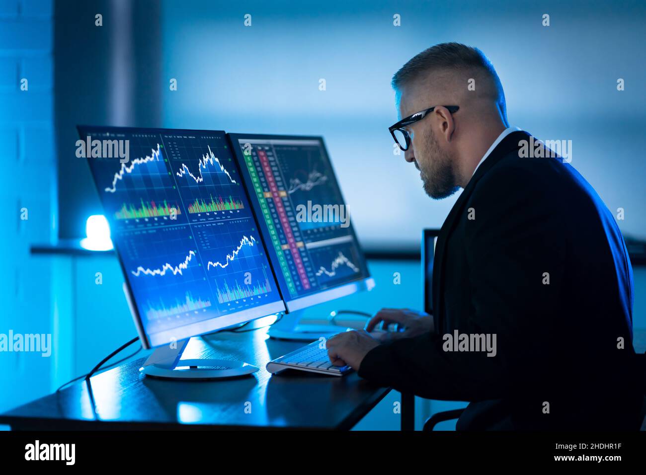 Stock Trader Man Using Multiple Computer Monitors Stock Photo - Alamy