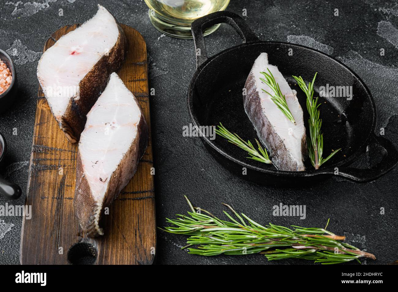 Raw halibut set, with ingredients and rosemary herbs, on black dark ...