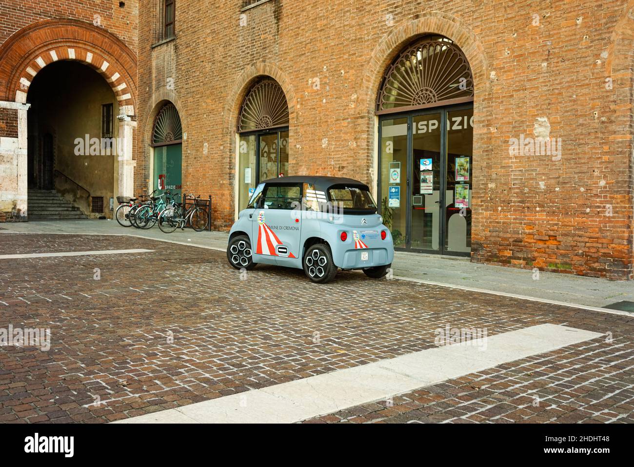 Small electric blueEV citroen ami city car in an ancient Cremona city ...