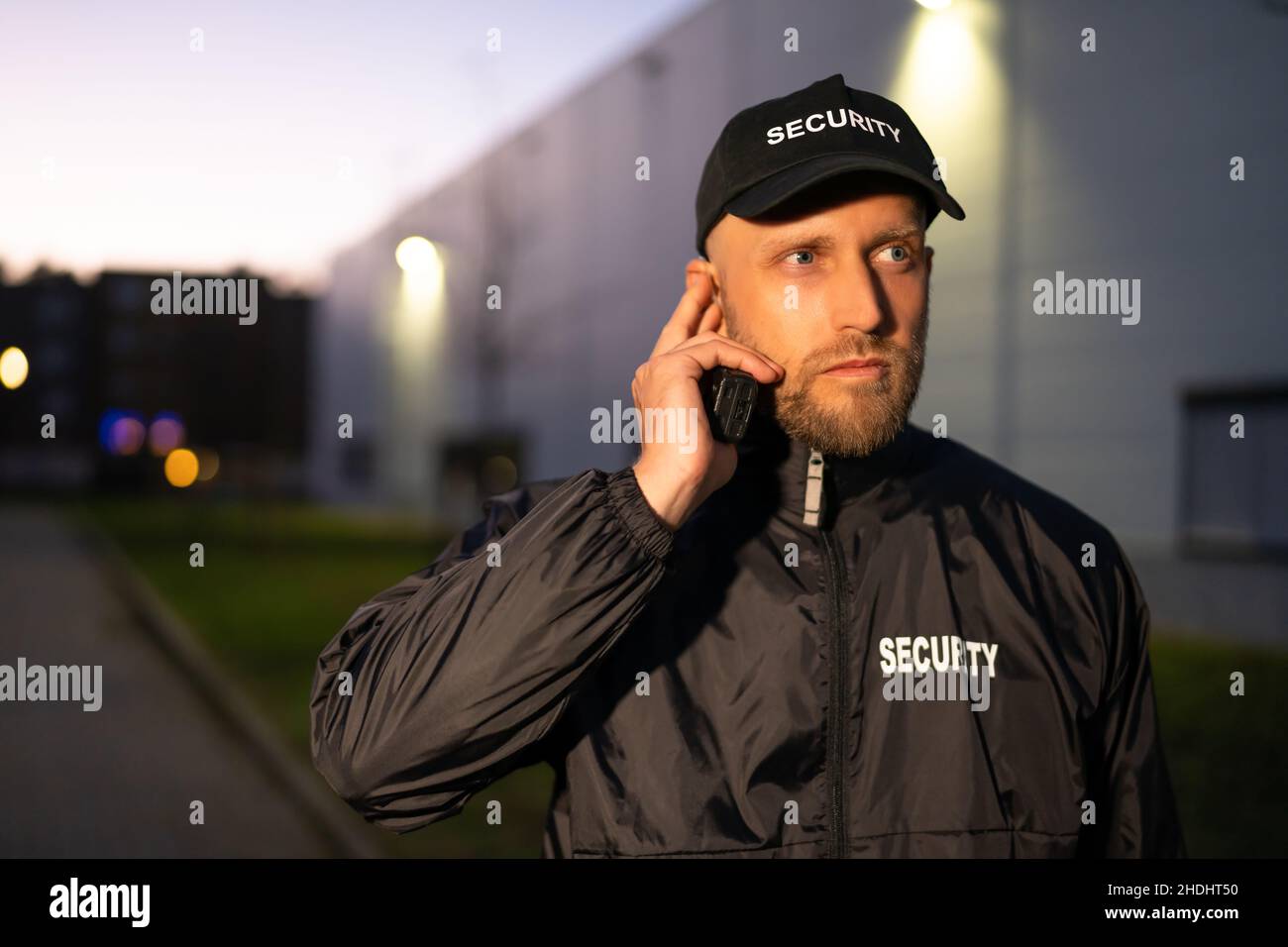 Security Guard Standing In Front Of Building At Night Stock Photo - Alamy