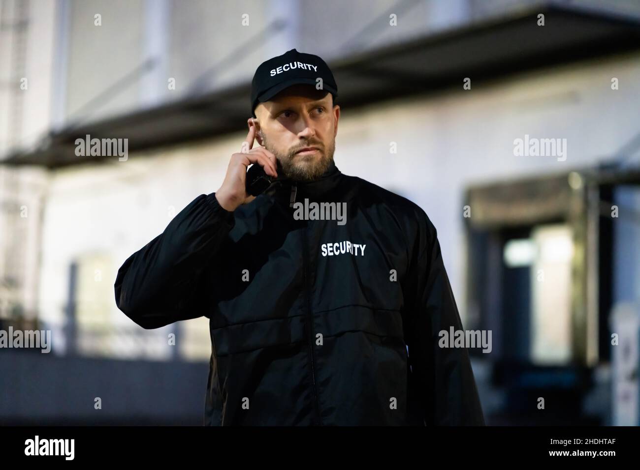 Security Guard Standing In Front Of Building At Night Stock Photo - Alamy