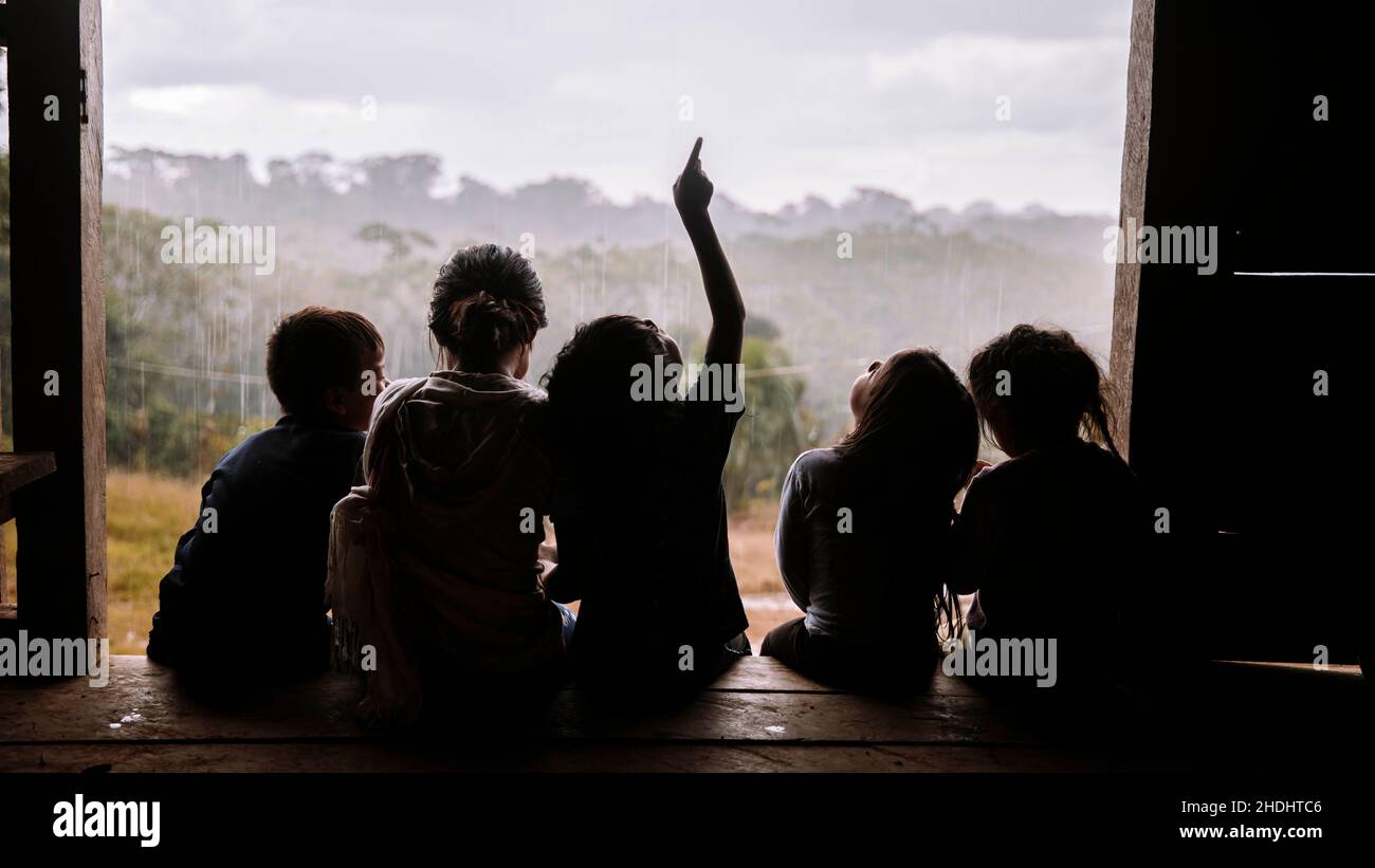 Indigenous Kids sitting down in the Amazon Rainforest, Ecuador Stock ...