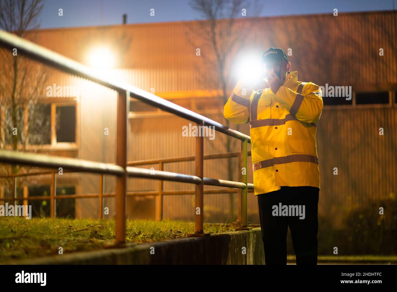 Security Guard Walking Outdoors With Flashlight At Night Stock Photo ...