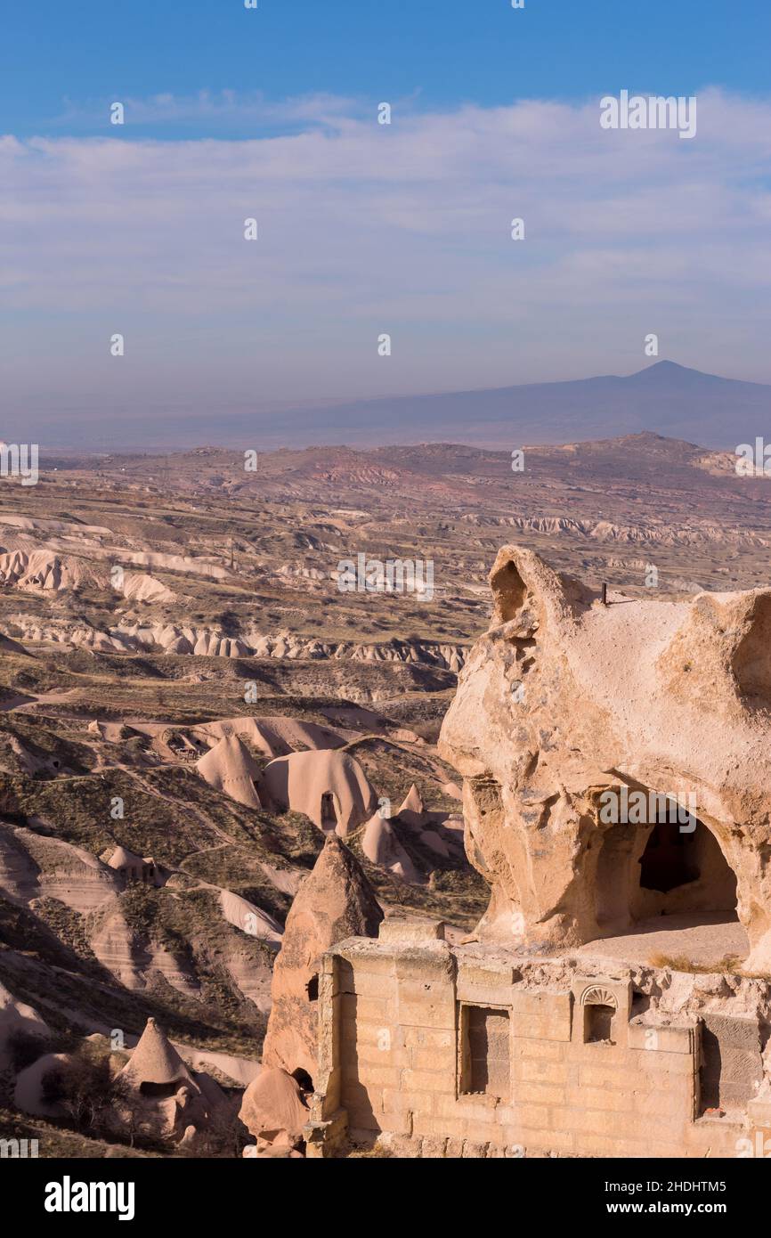 Cave houses and buildings in Cappadocia, Turkey. Stone peaks with doors ...