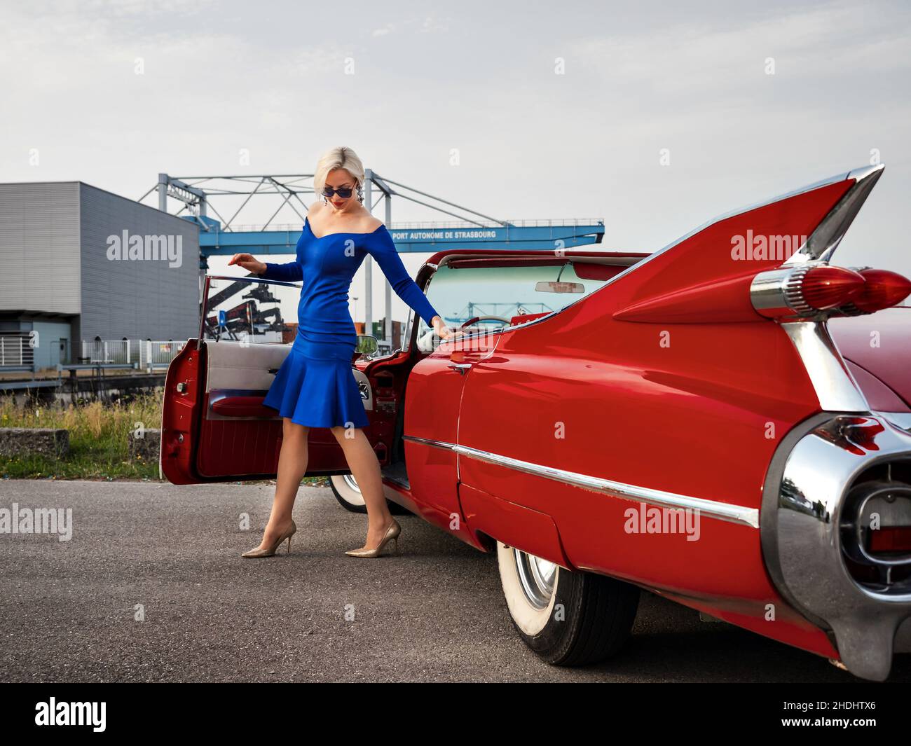 60-s oldtimer red Cadillac and a beautiful young girl. France Stock Photo - Alamy