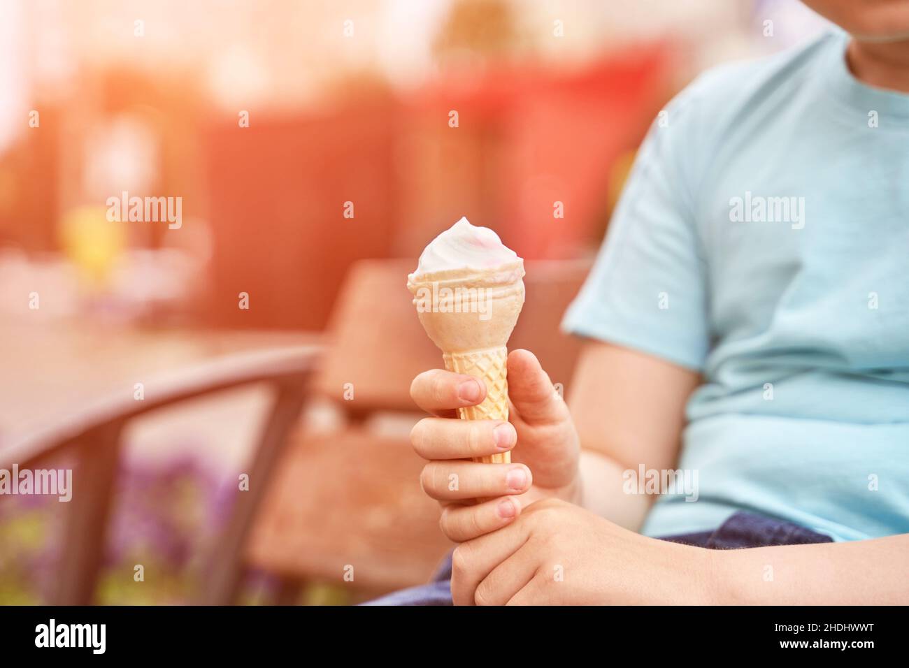 Pretty fun kid eating ice cream at park. Vacation concept. Staycation ...