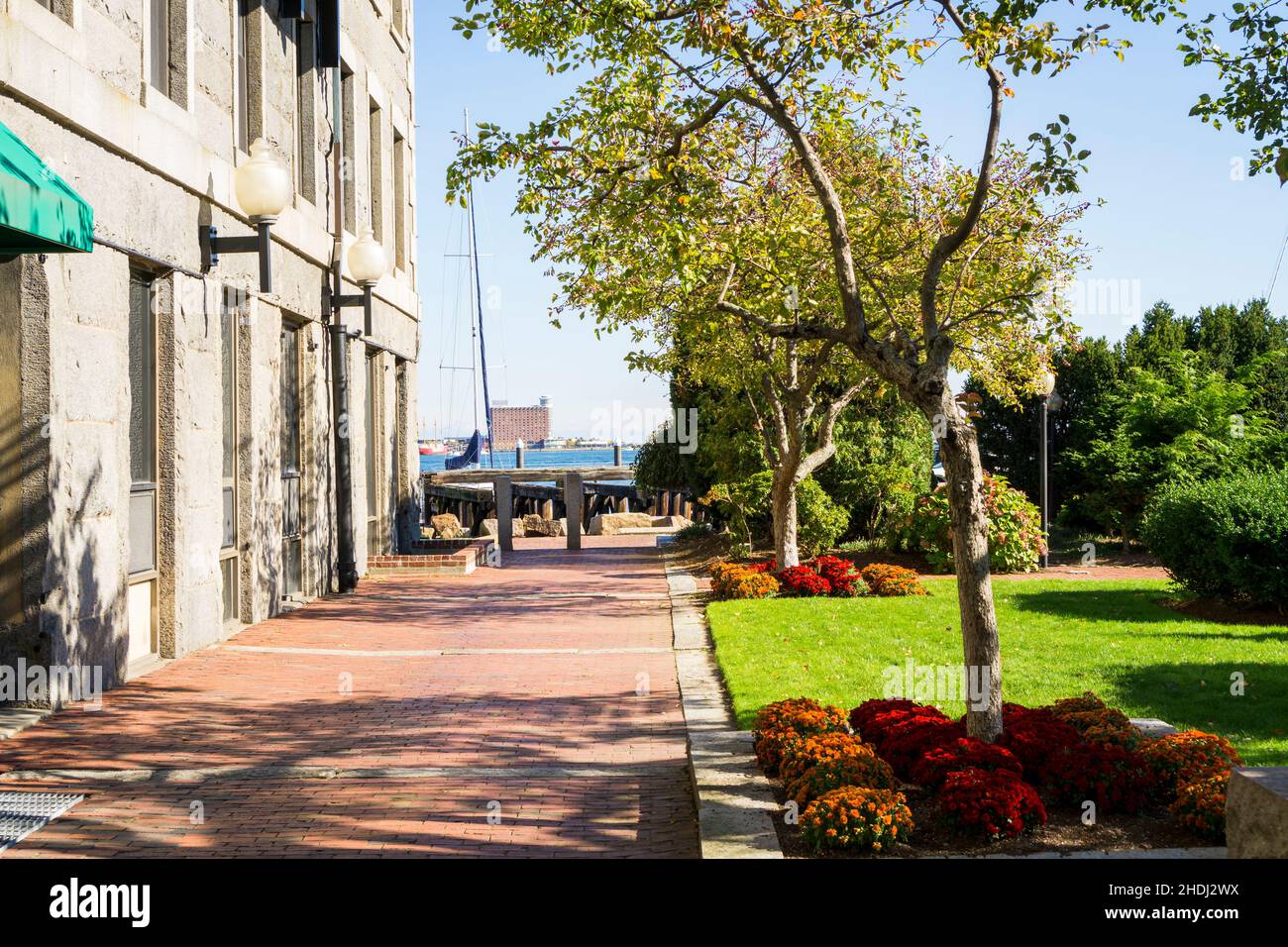 View of a sidewalk with facade of the building on one side and park ...