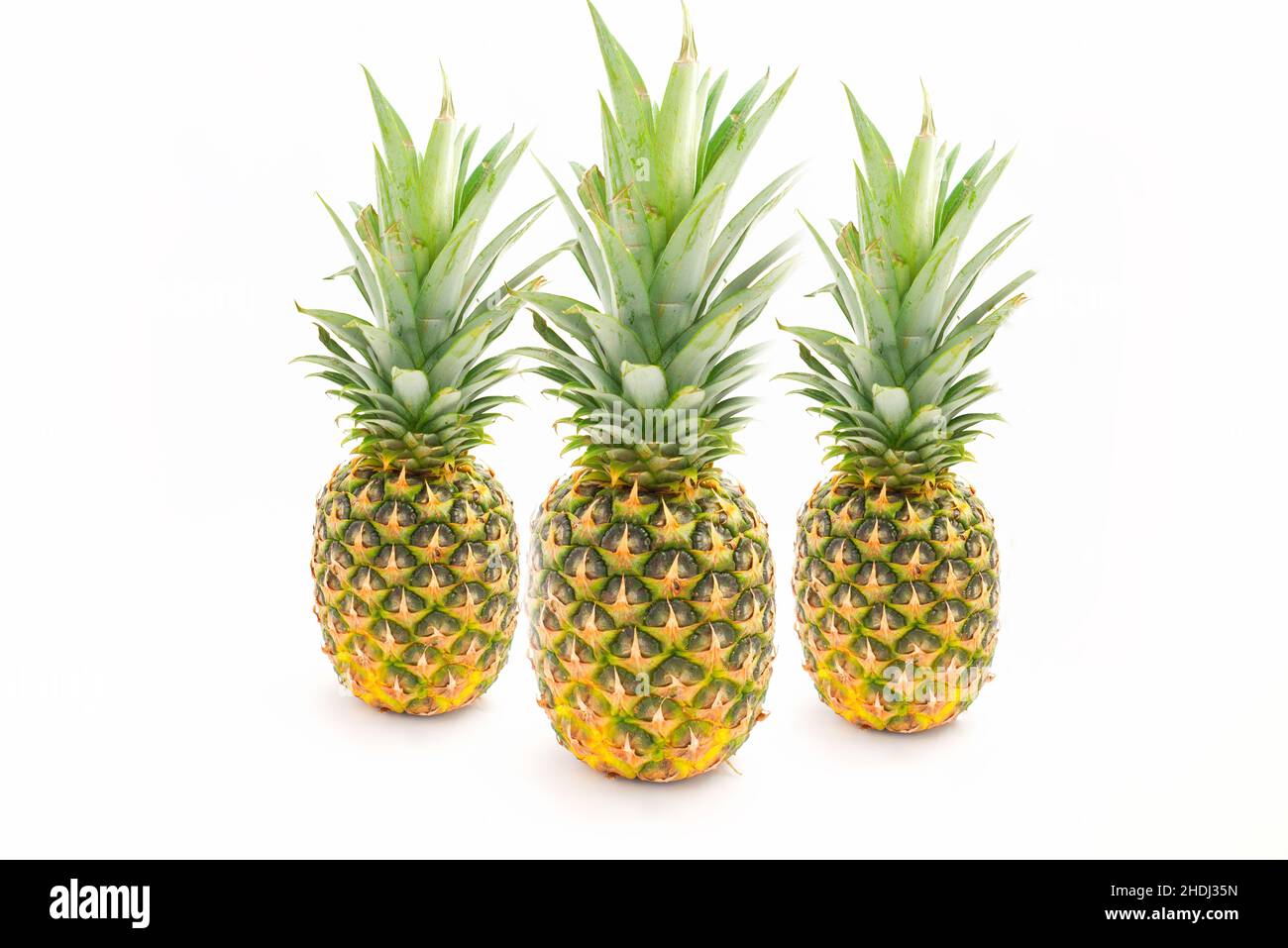 Three whole pineapple isolated on white background Stock Photo - Alamy