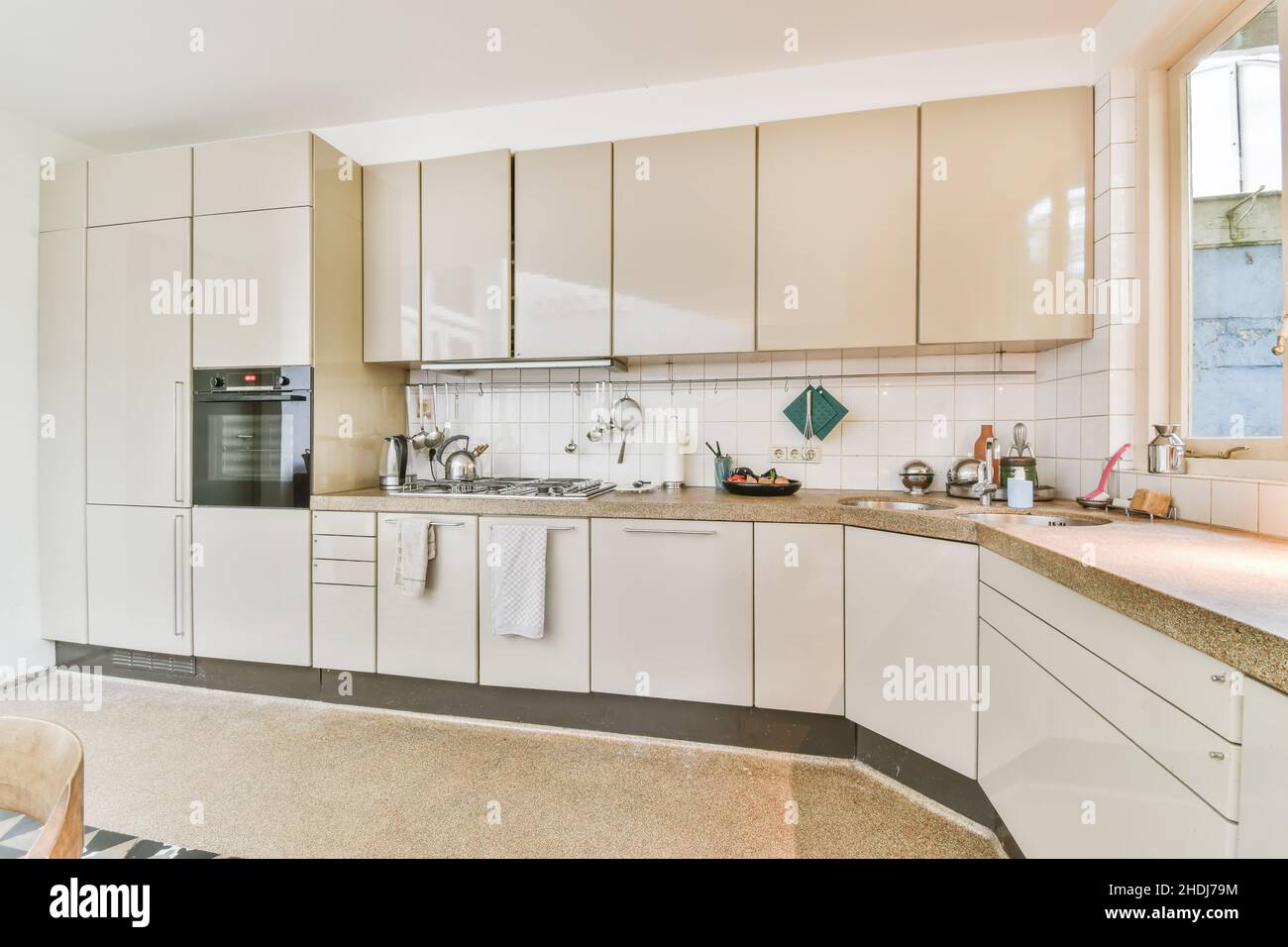 Chic kitchen with modern large beige kitchen set Stock Photo - Alamy