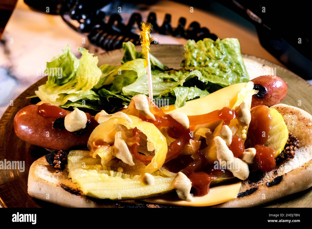 The works hot dog with retro landline corded phone in the background ...