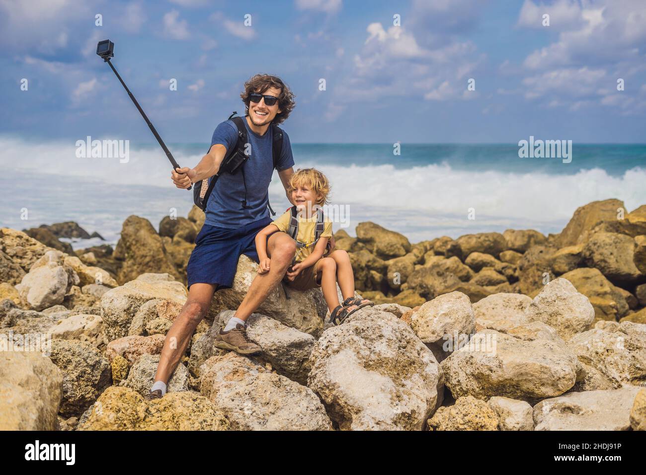 Dad and son travelers on amazing Melasti Beach with turquoise water ...